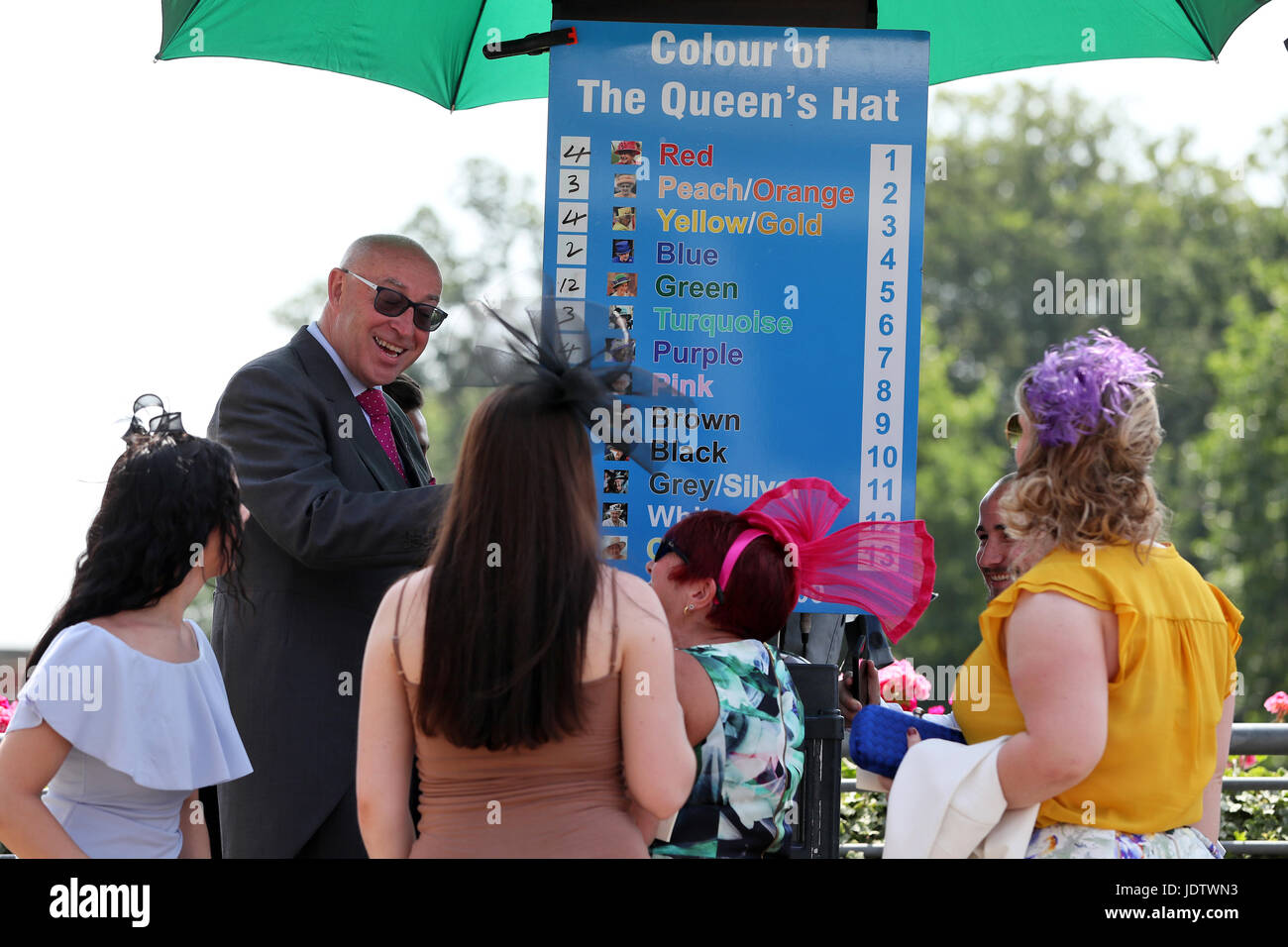 A bookmaker takes bets on the coolour o the Queen's hat during day two ...