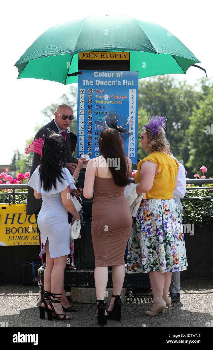 A bookmaker takes bets on the coolour o the Queen's hat during day two ...