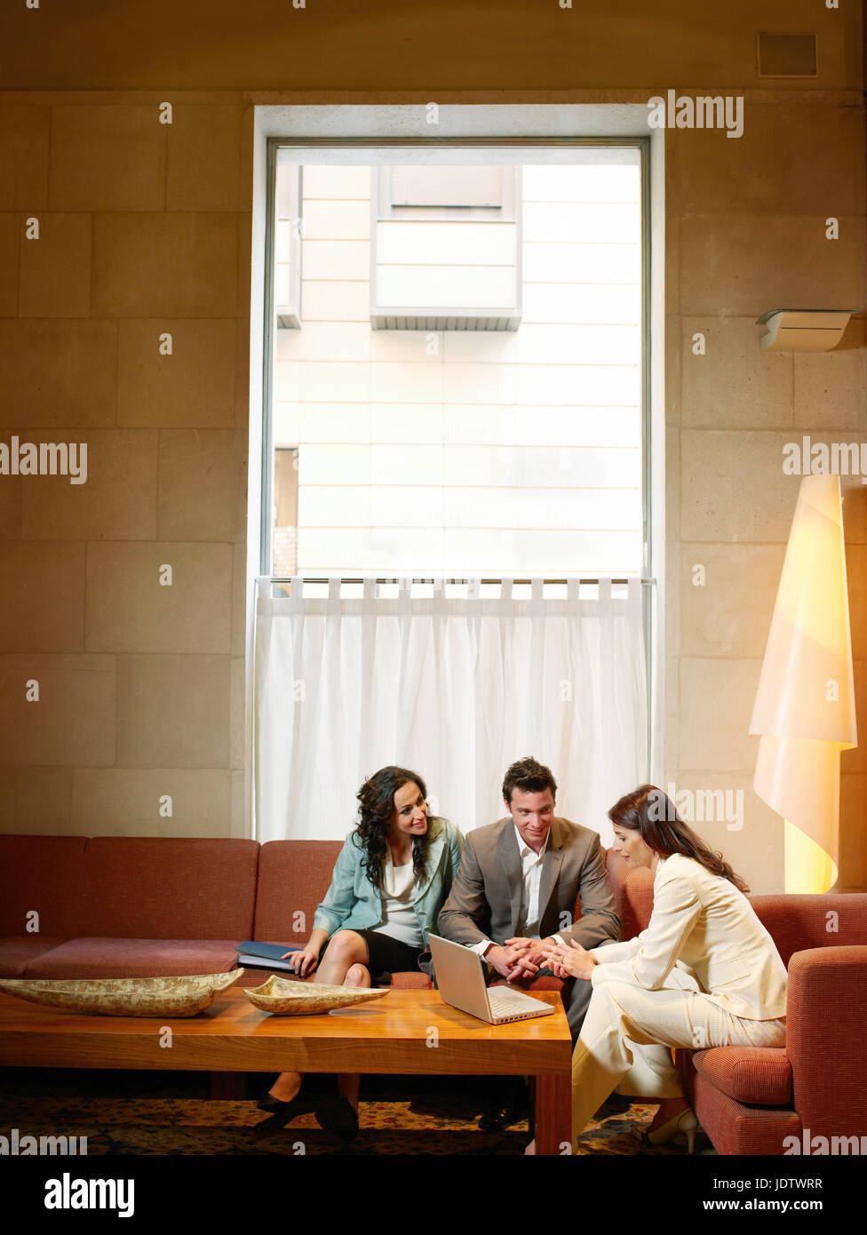 Team meeting in hotel lobby Stock Photo - Alamy
