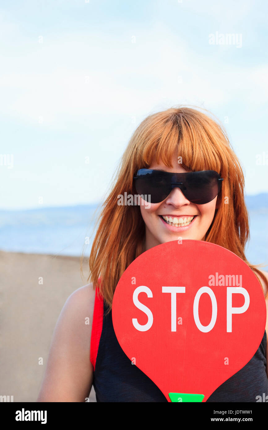 Young woman showing stop sign Stock Photo - Alamy