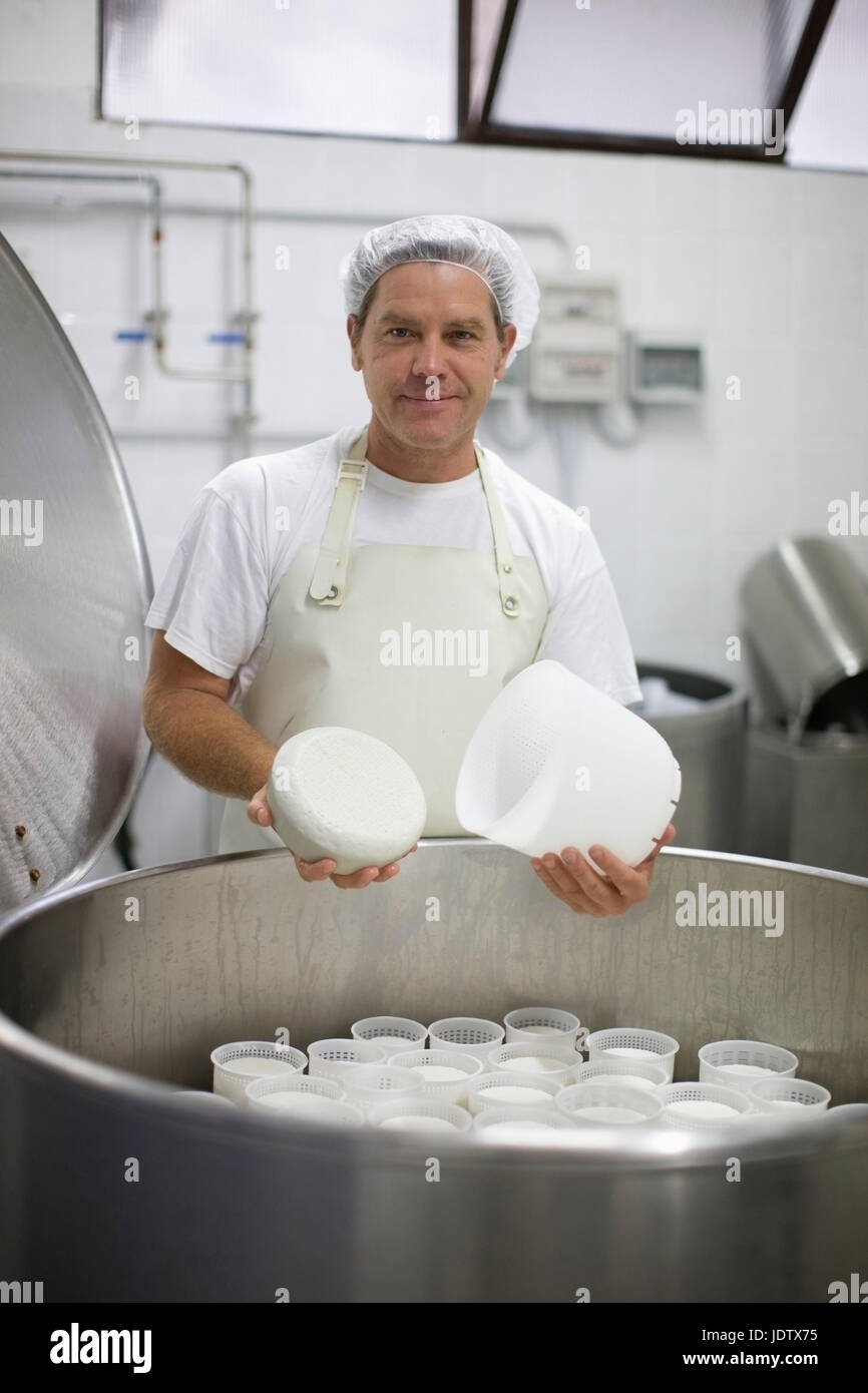 Goat farmer making cheese Stock Photo - Alamy