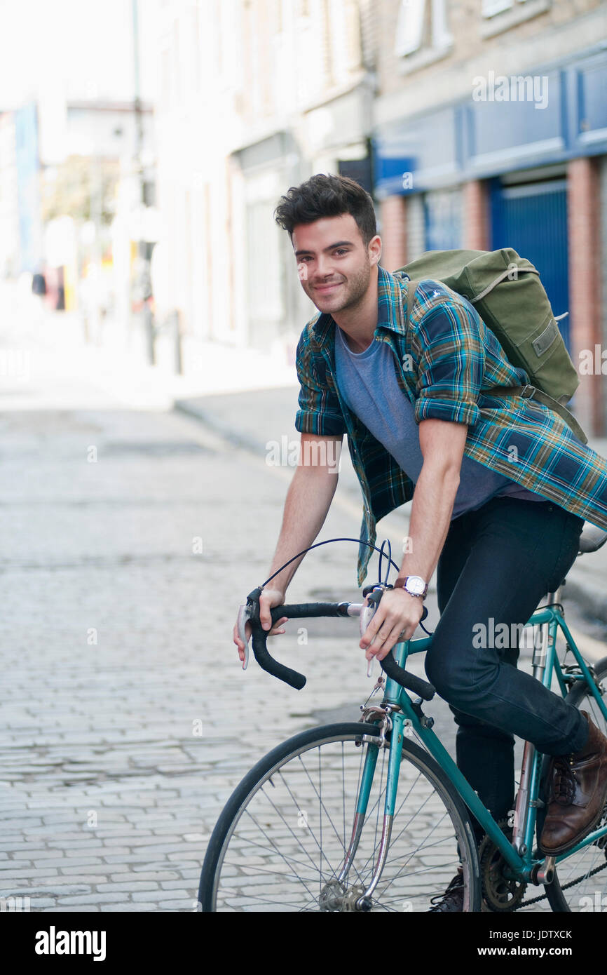Male riding bicycle, smiling Stock Photo - Alamy