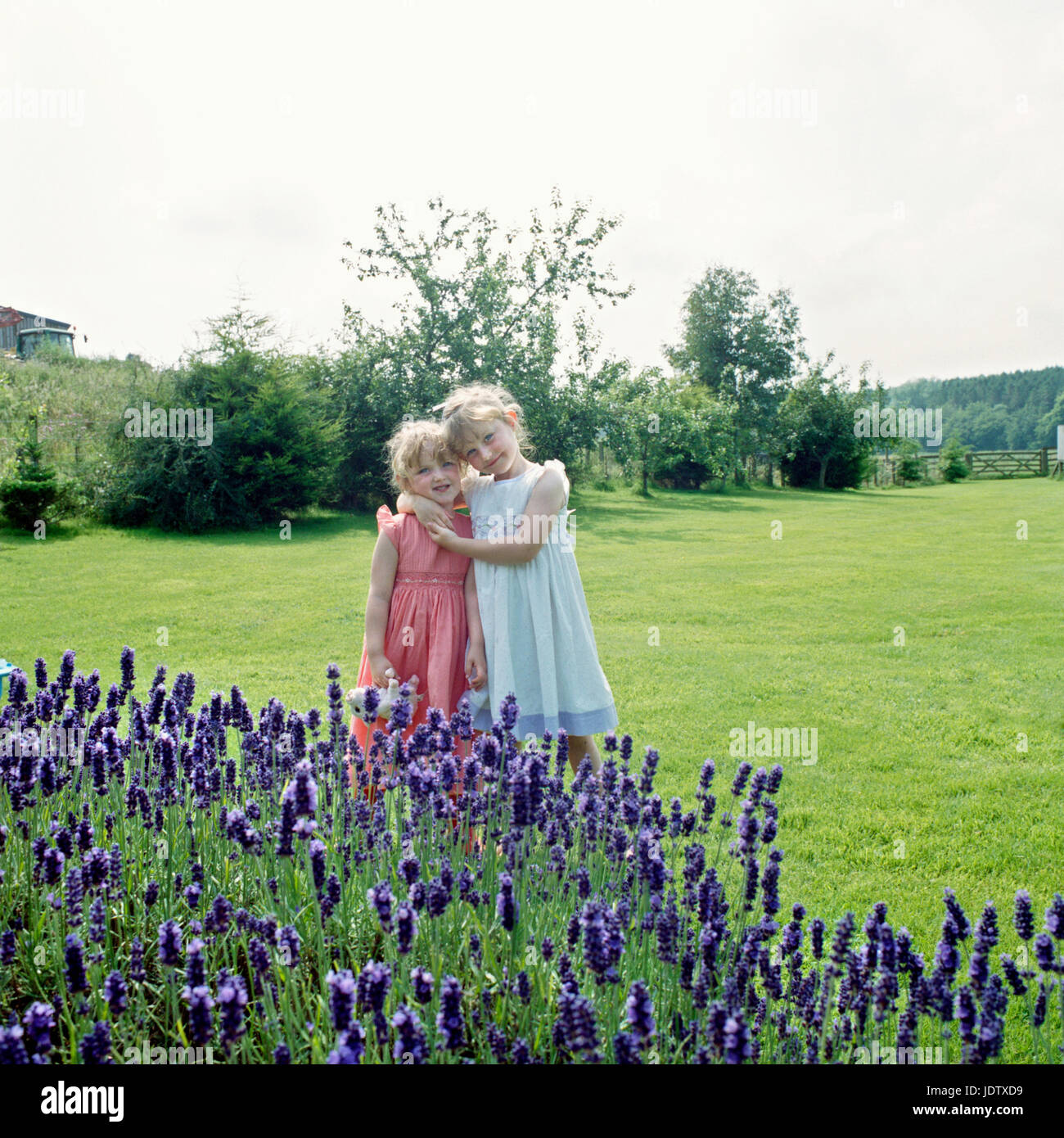 Two girls playing in garden Stock Photo - Alamy