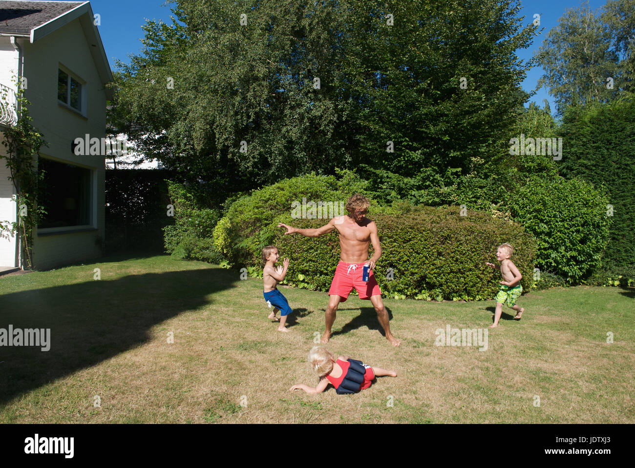 Children fighting a stronger man Stock Photo - Alamy