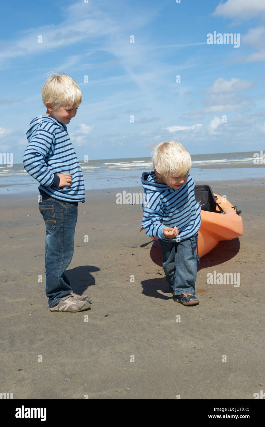 Big brother laughing at the little one Stock Photo - Alamy