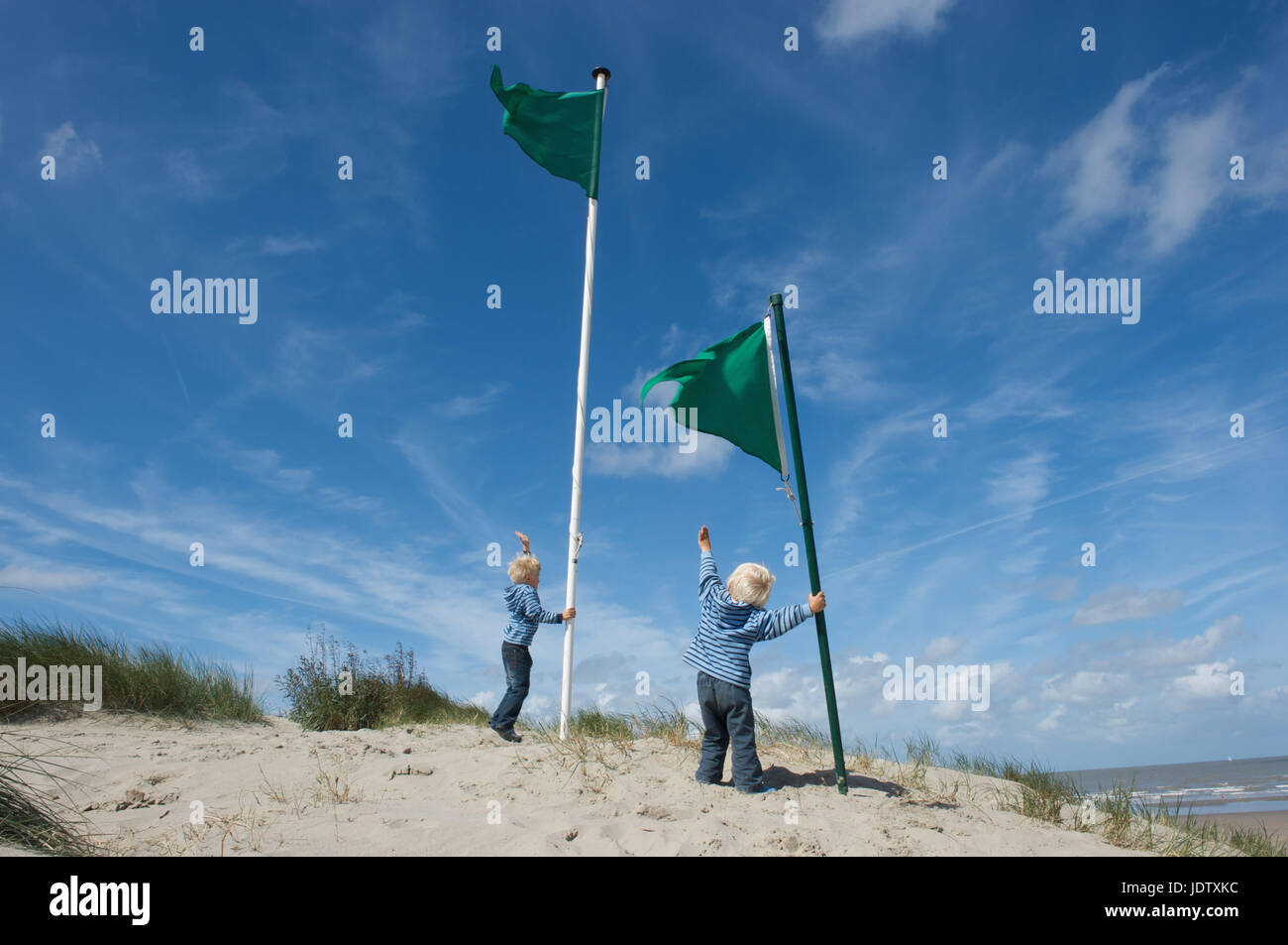 Two little brothers with flags by sea Stock Photo - Alamy