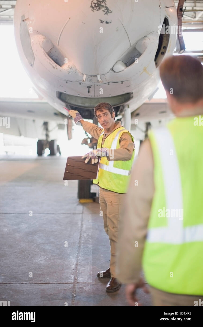 Aircraft workers talking on airfield Stock Photo - Alamy