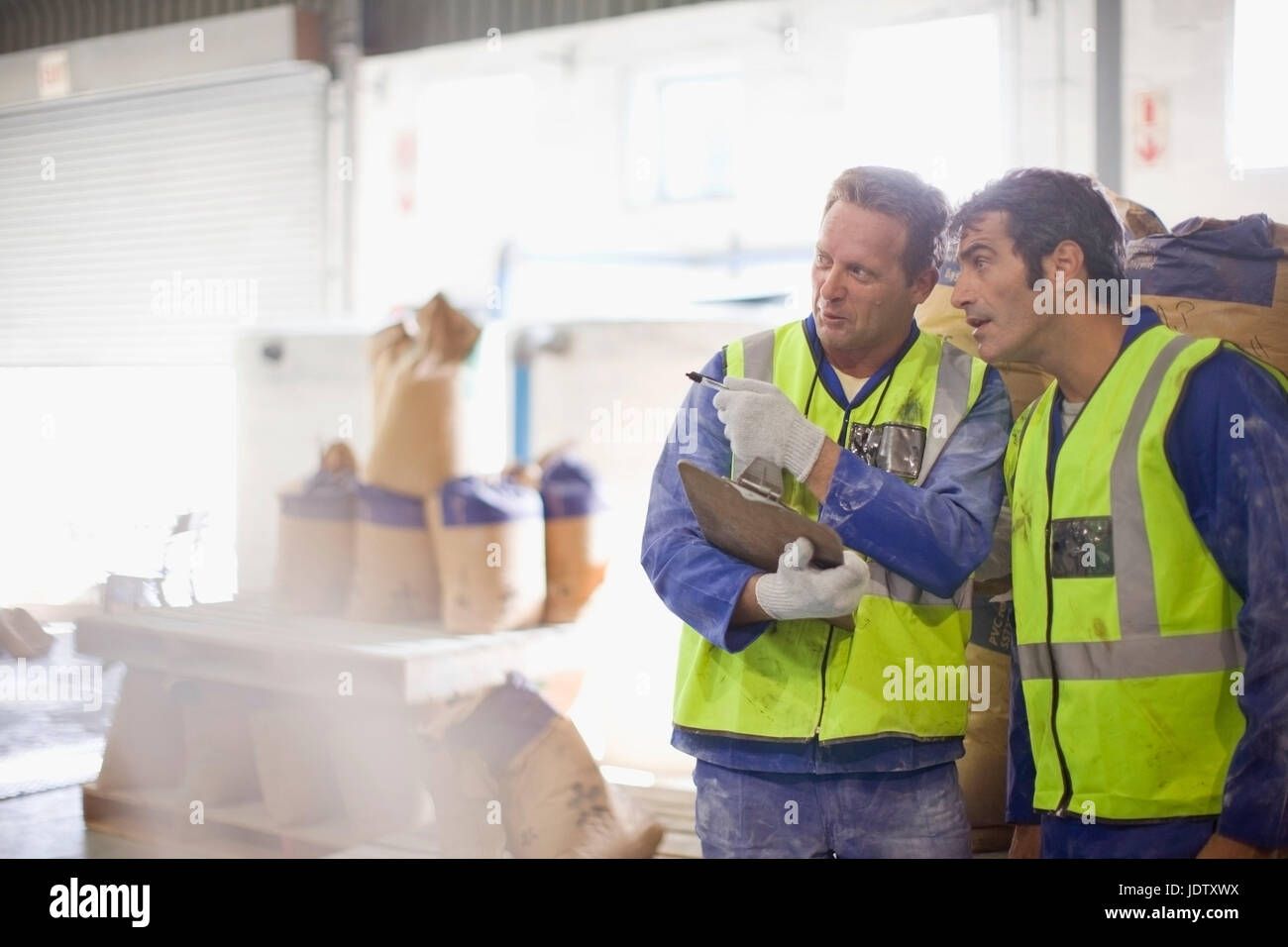 Workers talking in factory Stock Photo - Alamy