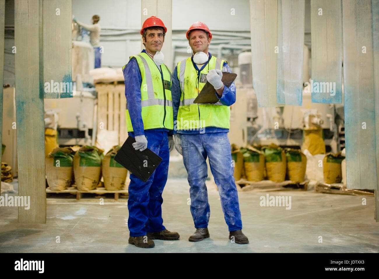 Workers with masks standing in factory Stock Photo - Alamy