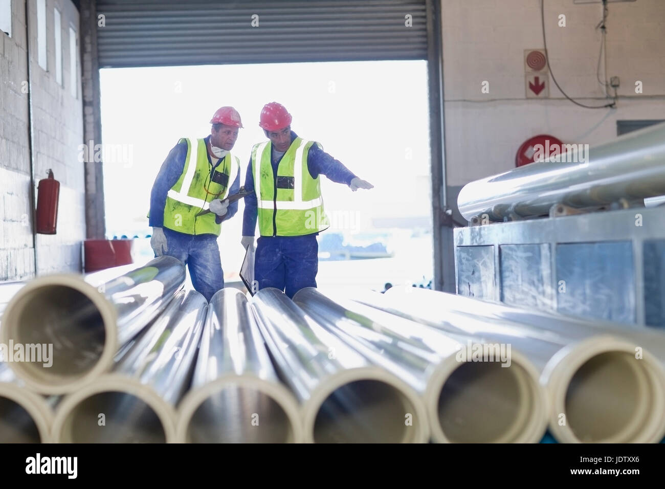 Workers examining product in factory Stock Photo - Alamy