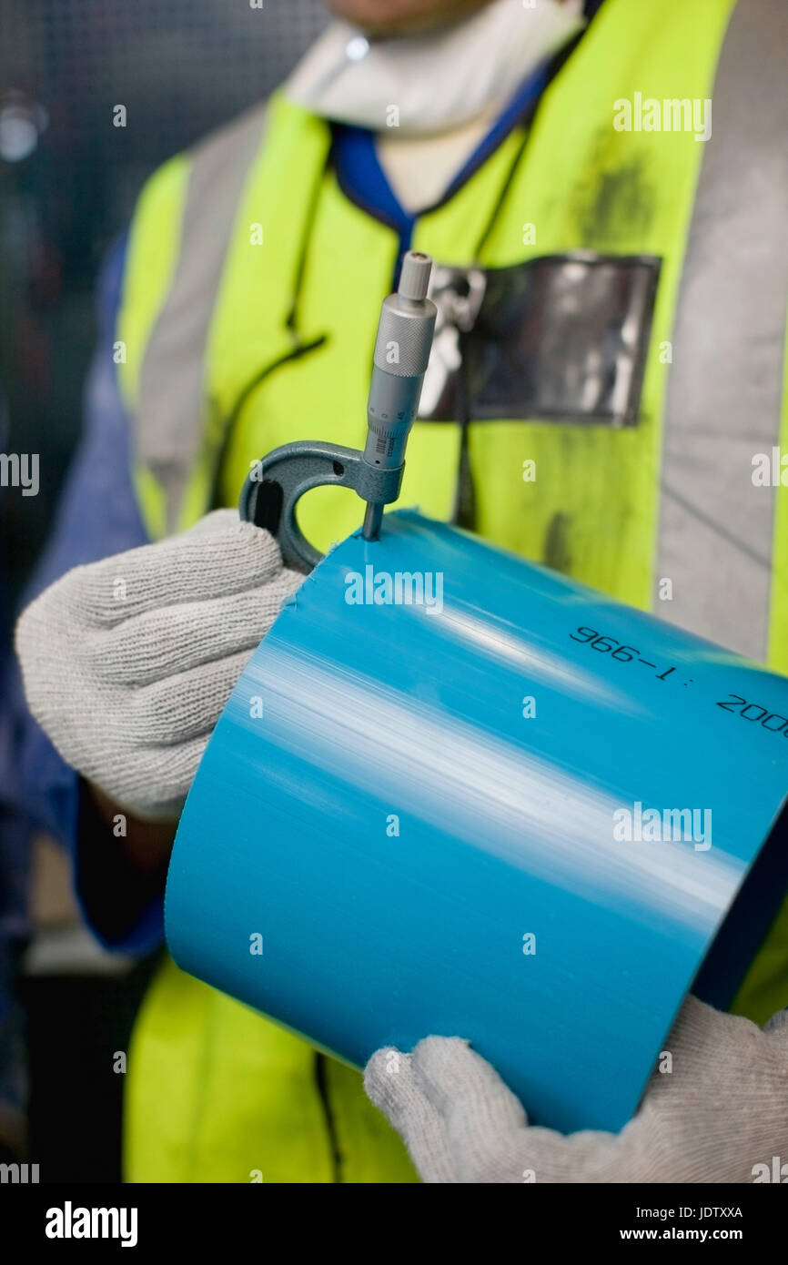 Worker checking product in factory Stock Photo - Alamy