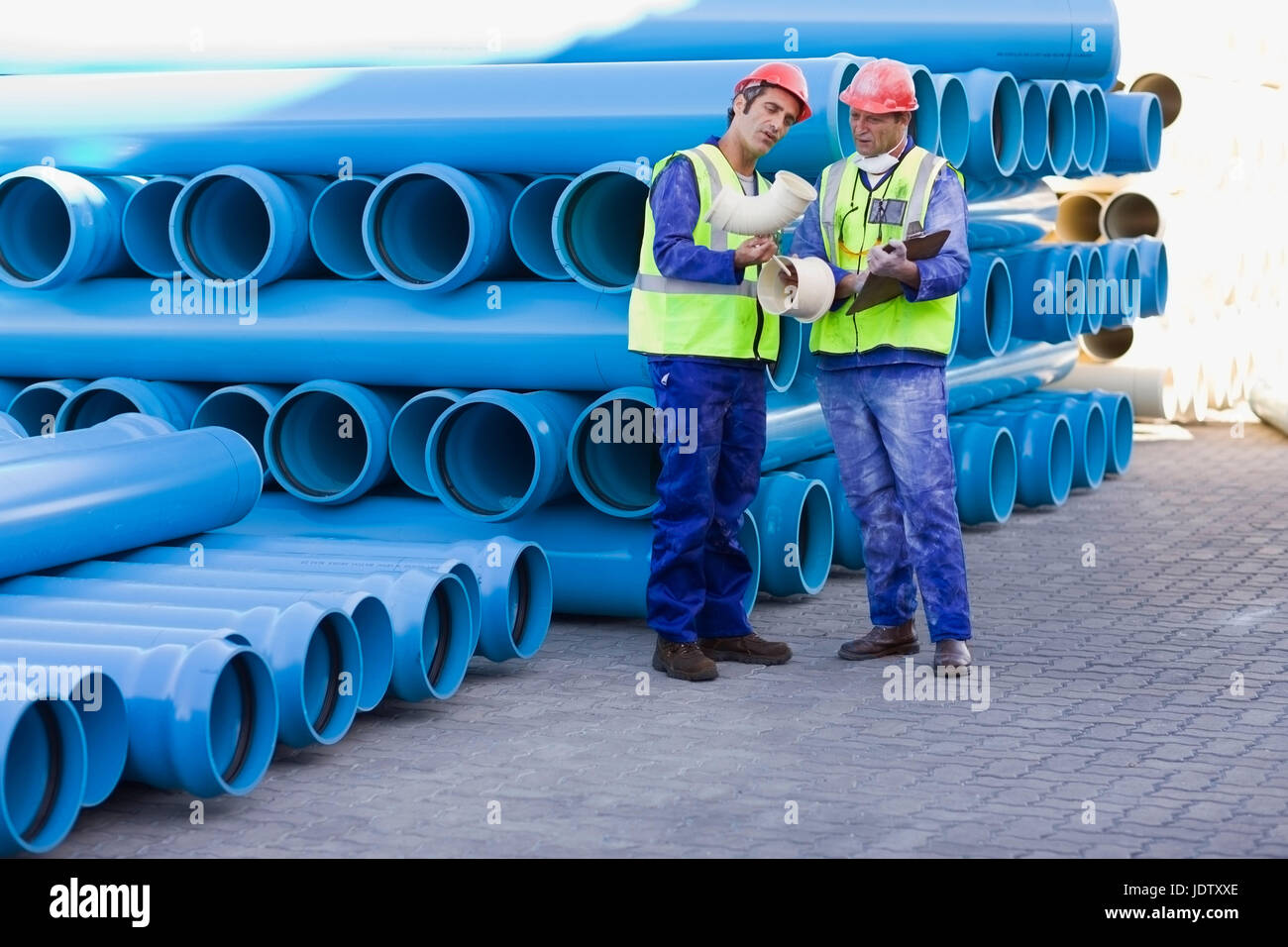 Workers checking product in factory Stock Photo - Alamy