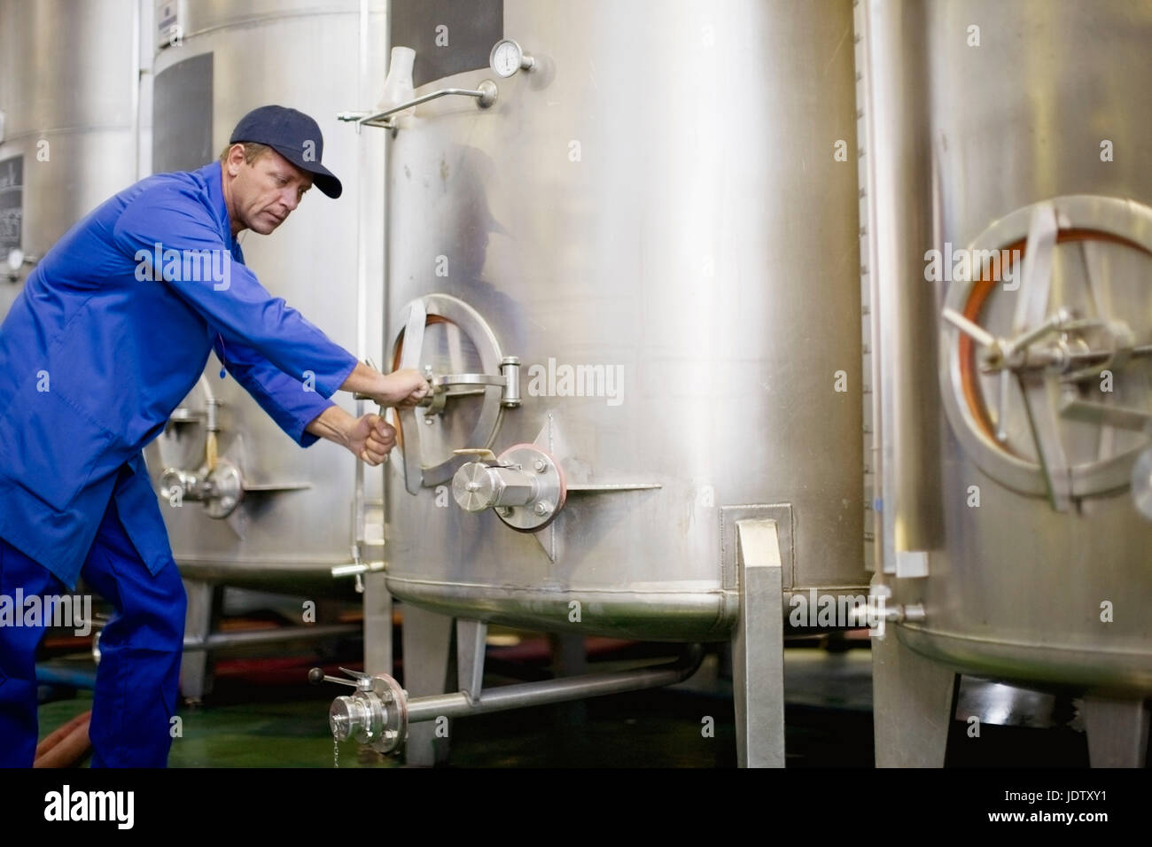Worker releasing valve in factory Stock Photo - Alamy