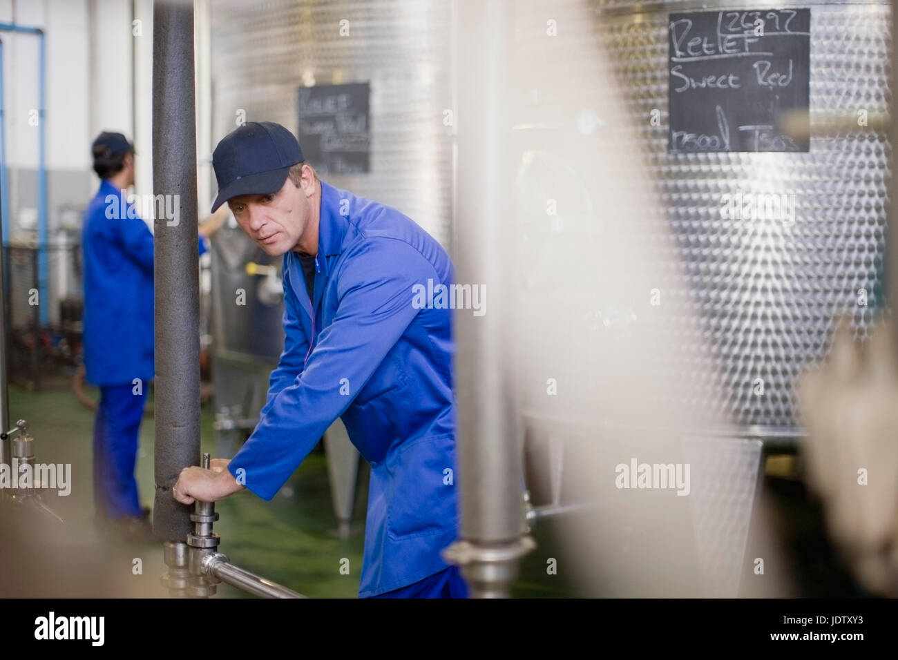 Worker releasing valve in factory Stock Photo - Alamy