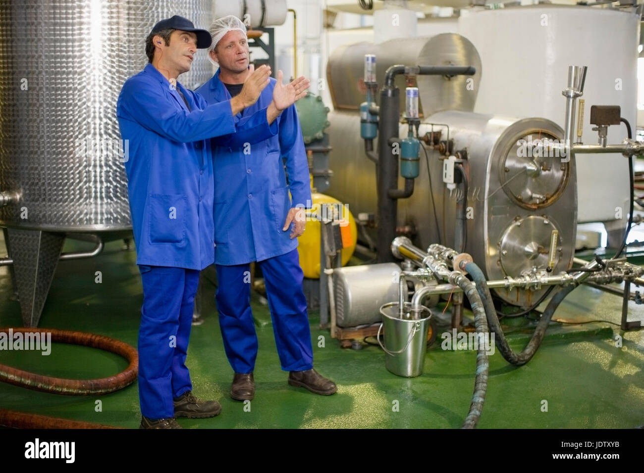 Workers talking in factory Stock Photo - Alamy