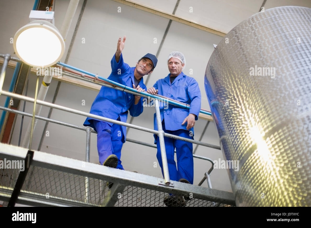 Workers talking in factory Stock Photo - Alamy