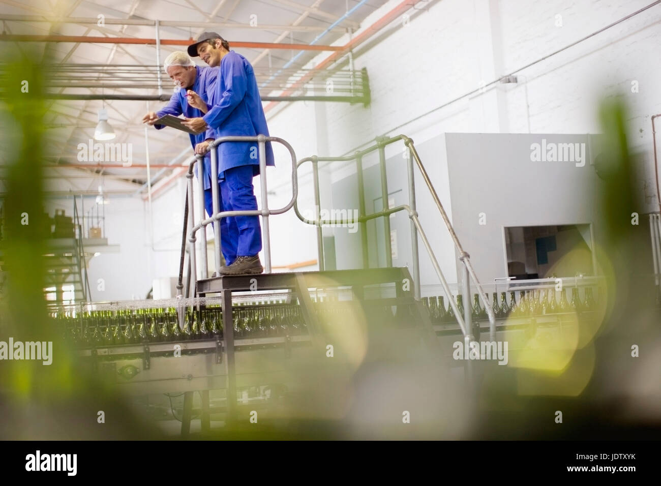 Workers talking in factory Stock Photo - Alamy