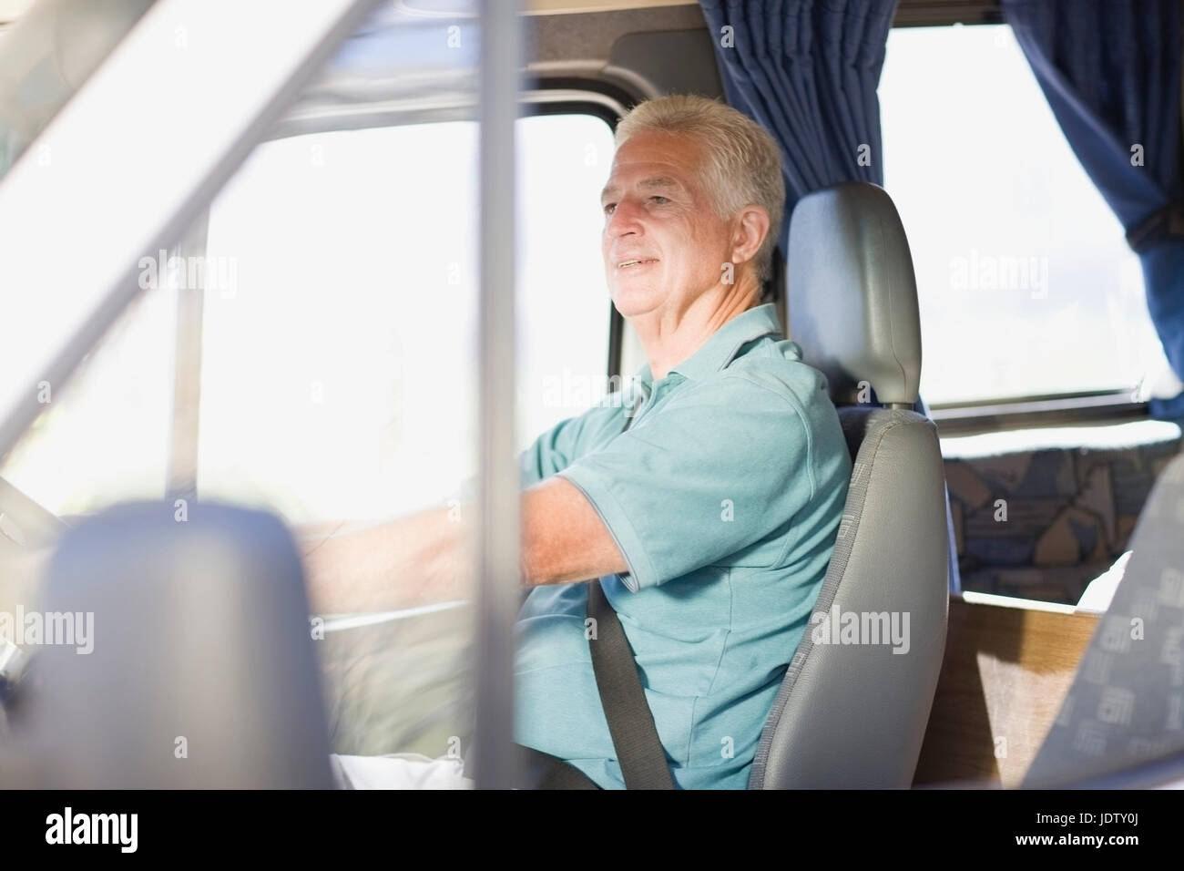 Smiling older man driving RV Stock Photo - Alamy