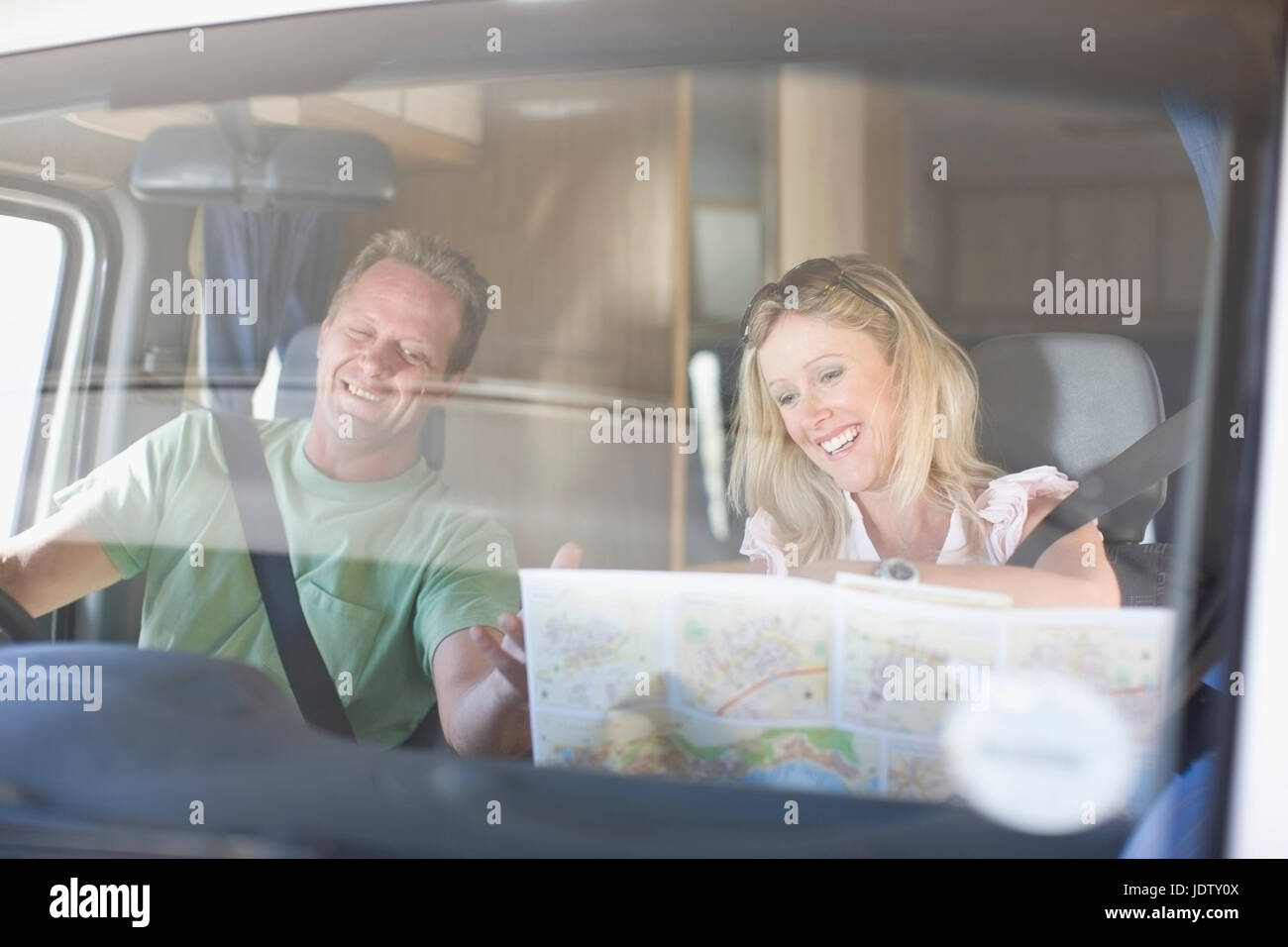 Couple reading map in RV Stock Photo - Alamy