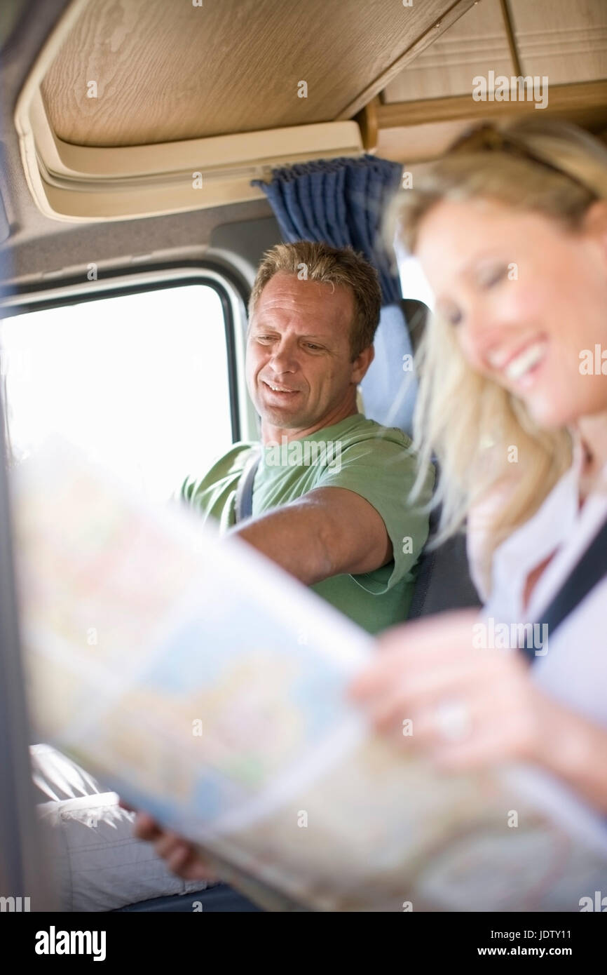 Couple reading map in RV Stock Photo - Alamy