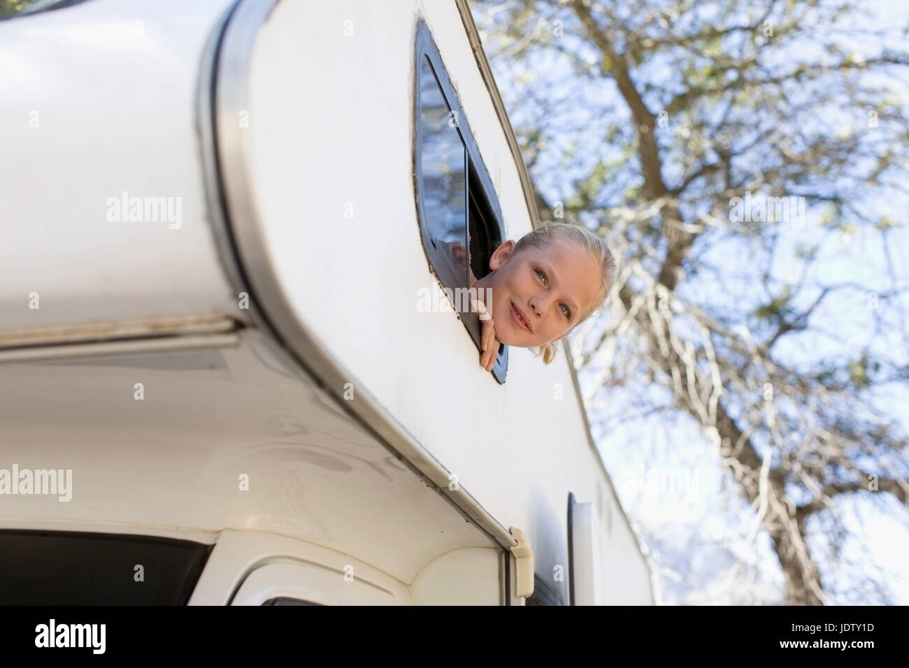 Girl peering out of RV Stock Photo - Alamy