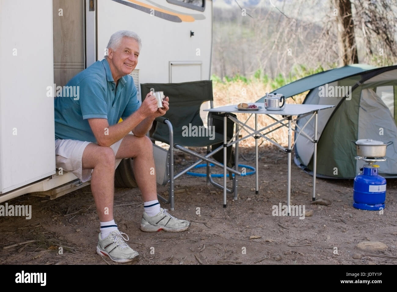 Older man camping with RV Stock Photo - Alamy