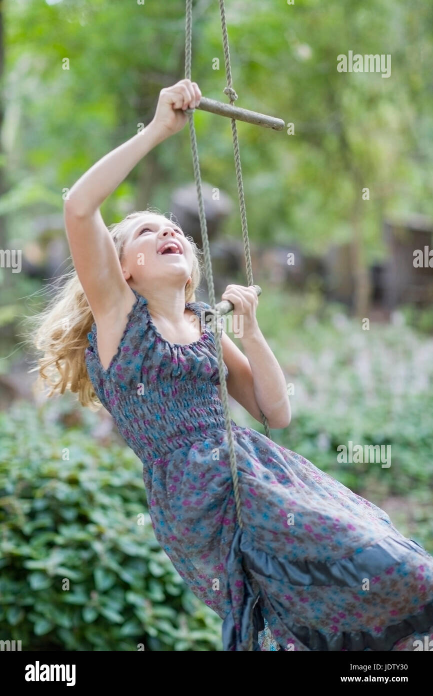 Girl climbing rope ladder Stock Photo - Alamy