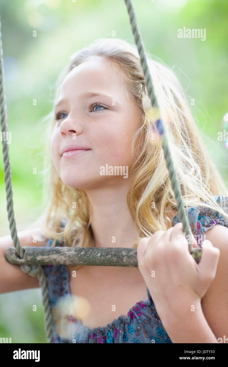 Girl climbing rope ladder Stock Photo - Alamy