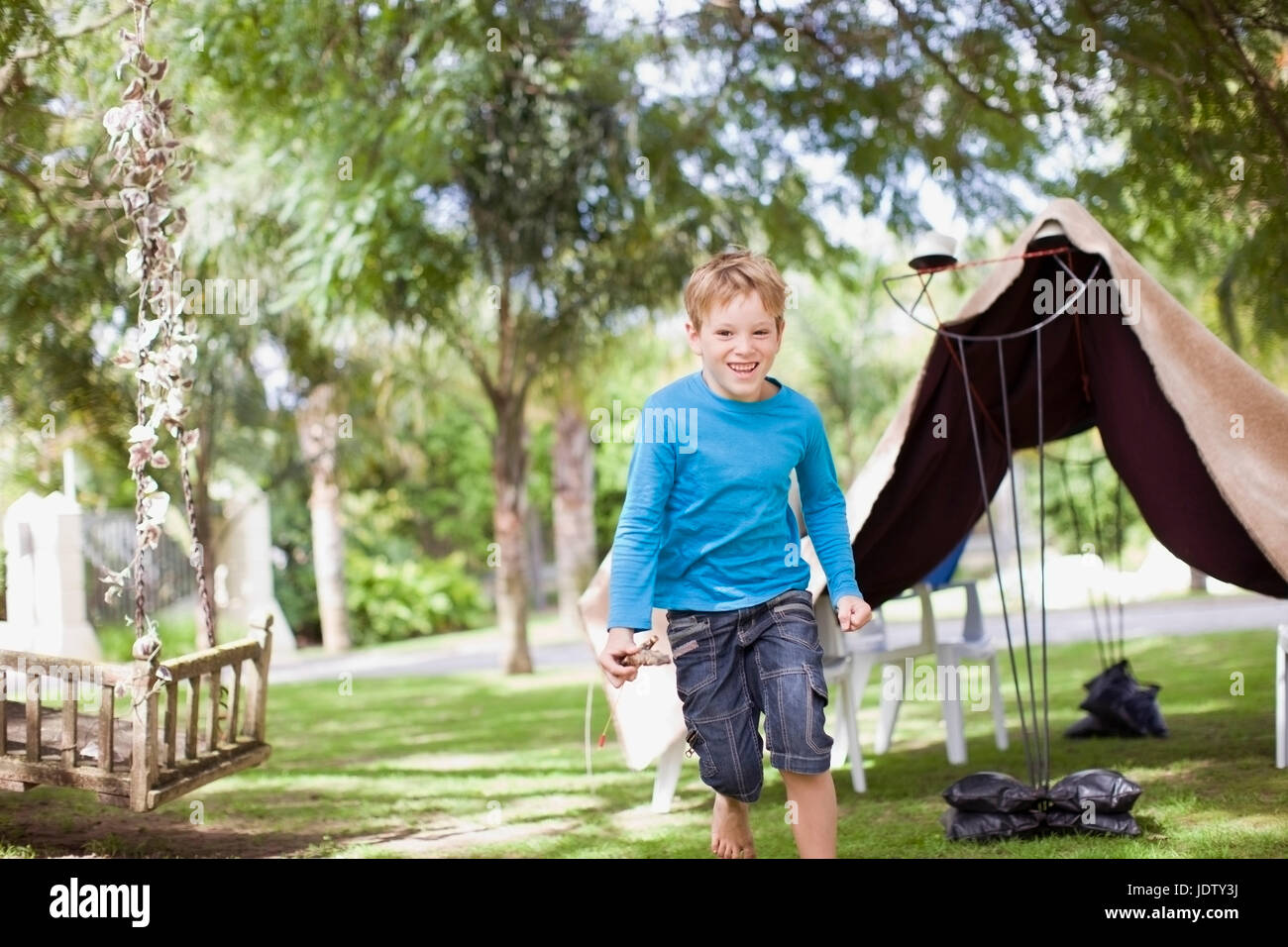 Boy playing in backyard Stock Photo - Alamy