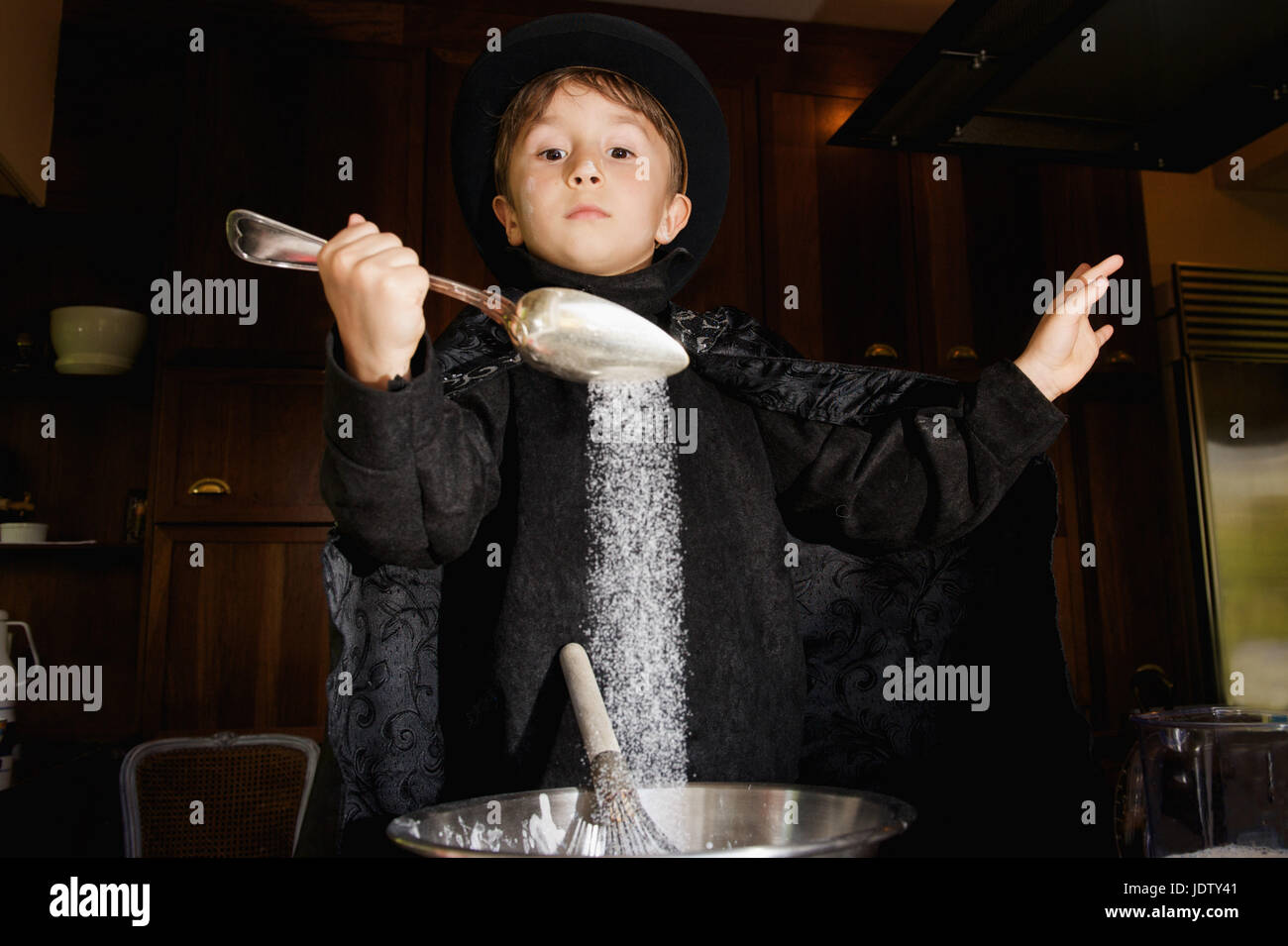Boy magician cooking in kitchen Stock Photo - Alamy