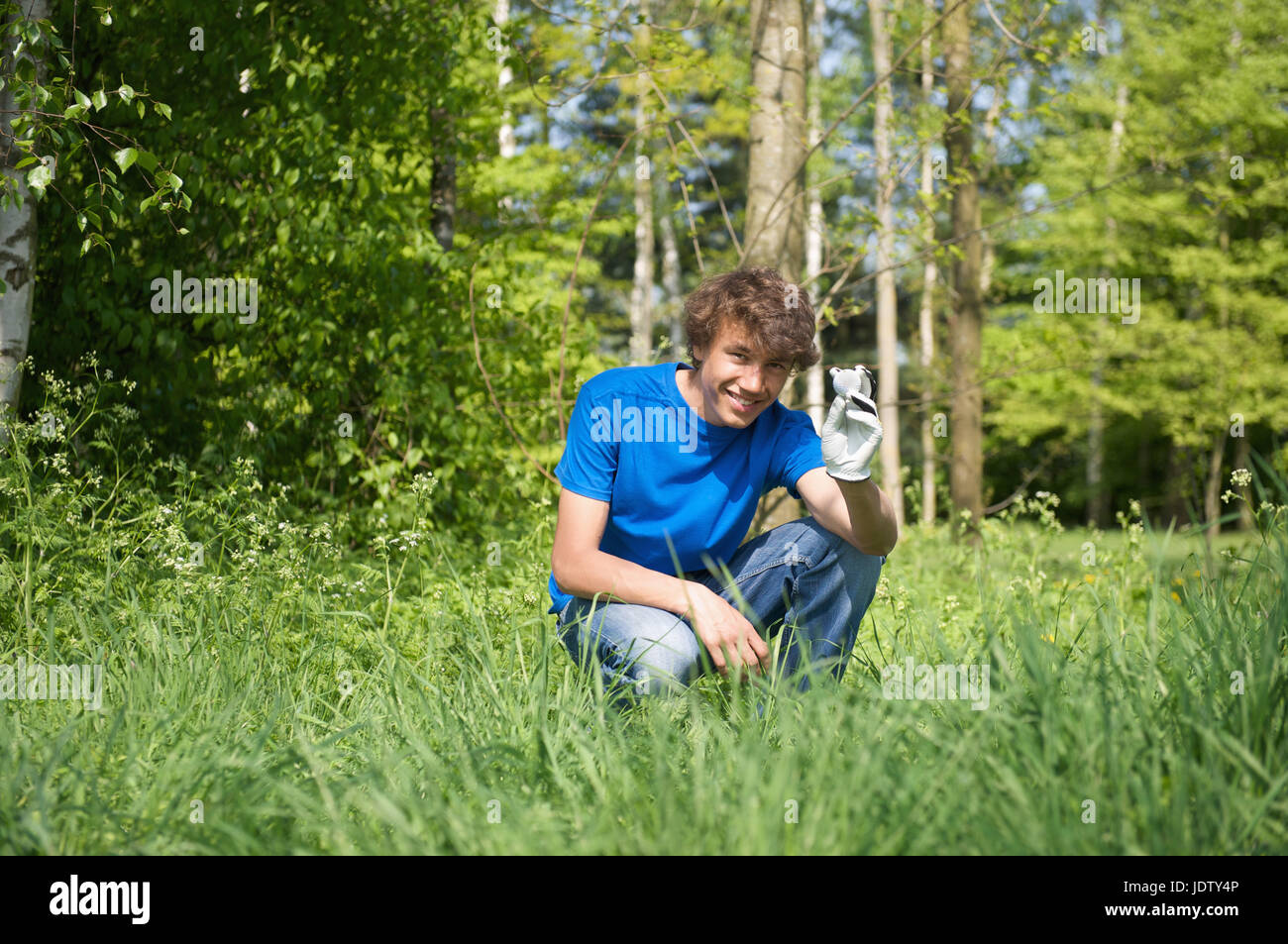 Smiling boy retrieving golf ball Stock Photo - Alamy