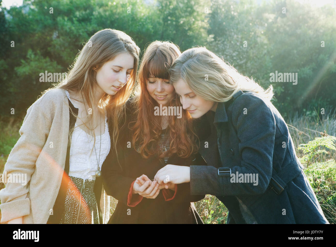 Teenage girls admiring something Stock Photo - Alamy