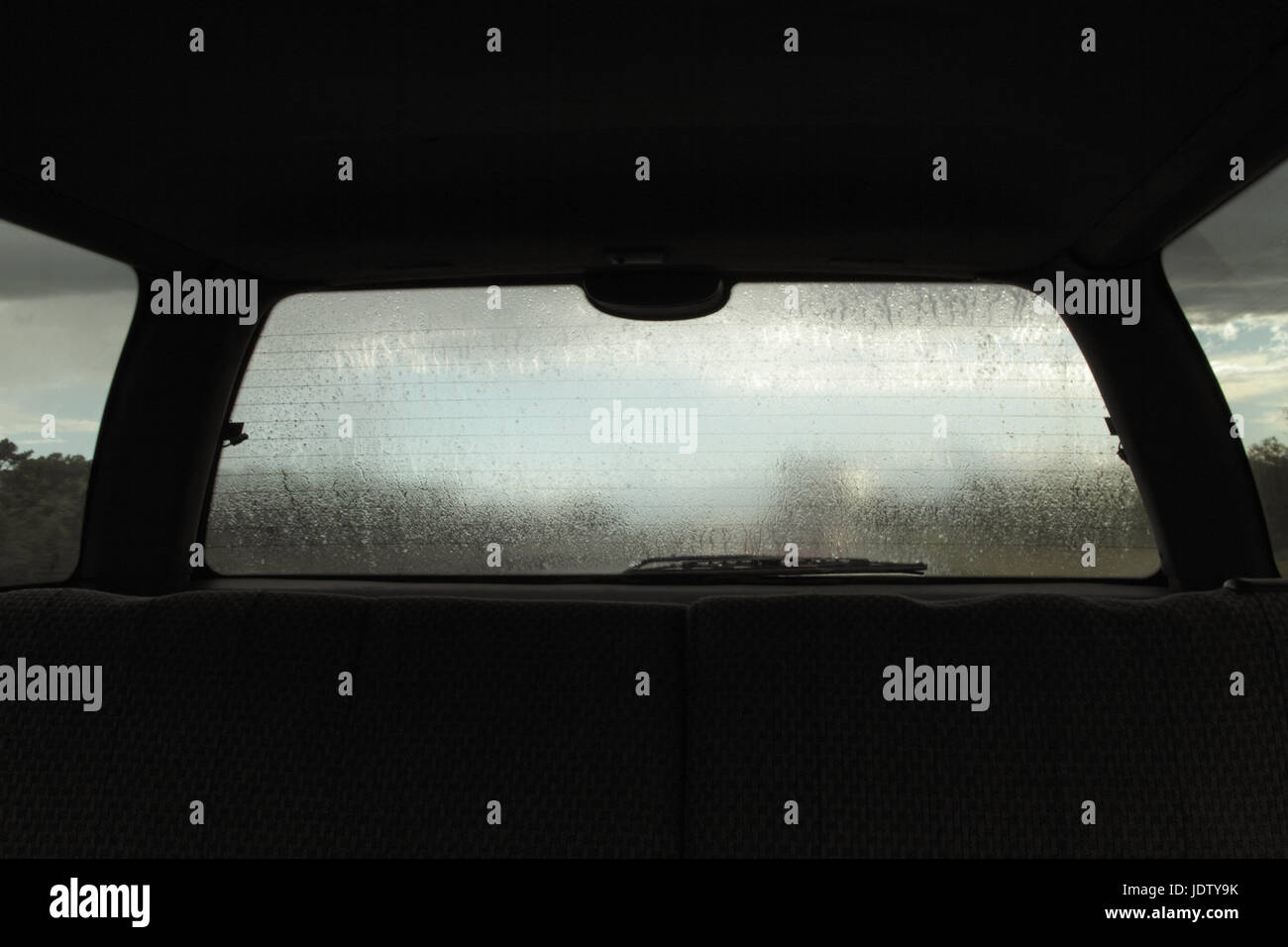 Rain on rear windshield of car Stock Photo - Alamy