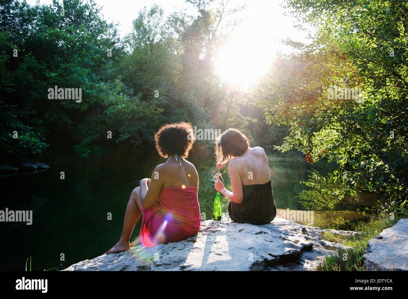 Women relaxing by river Stock Photo - Alamy