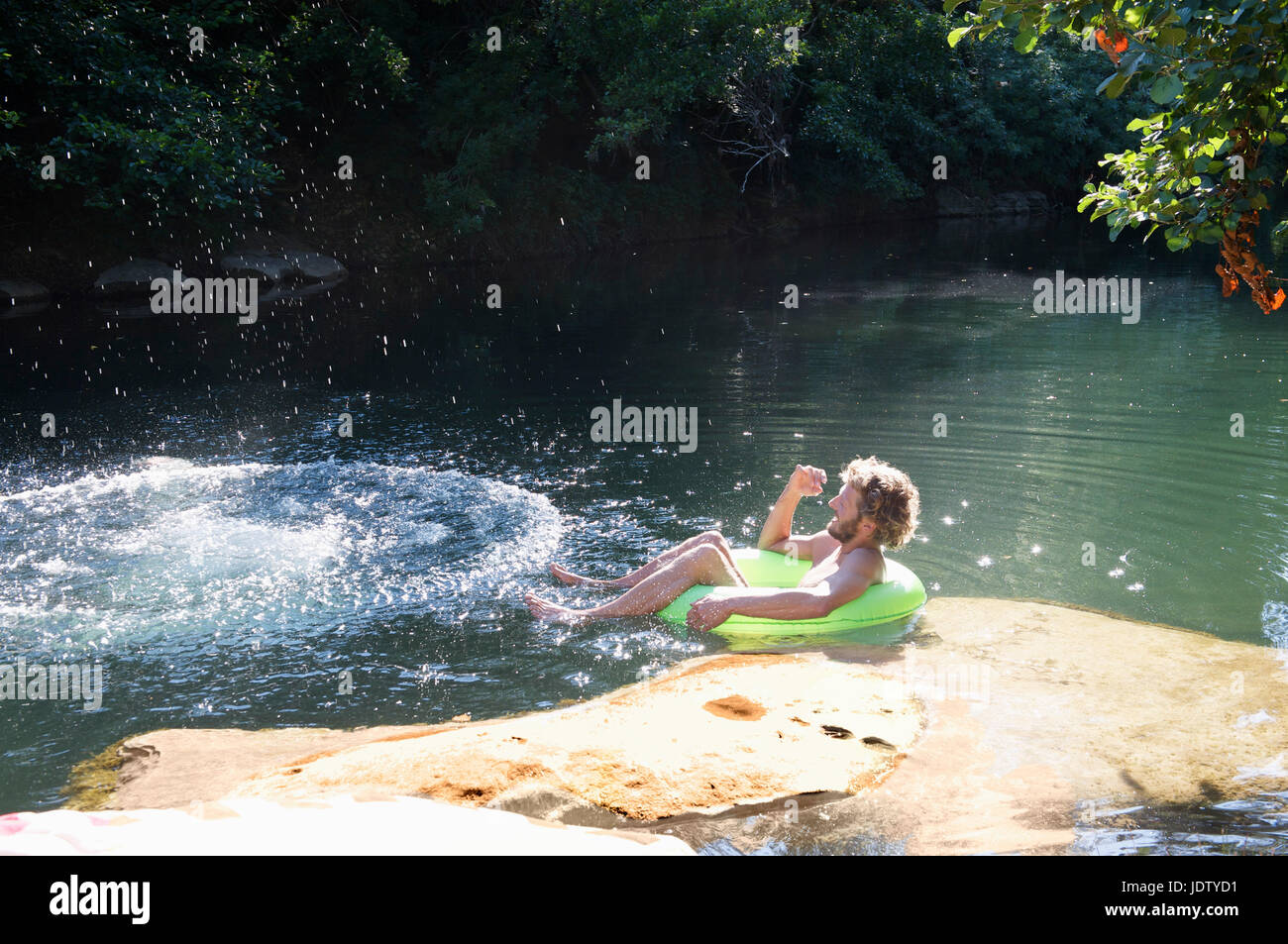 Men playing in river Stock Photo - Alamy