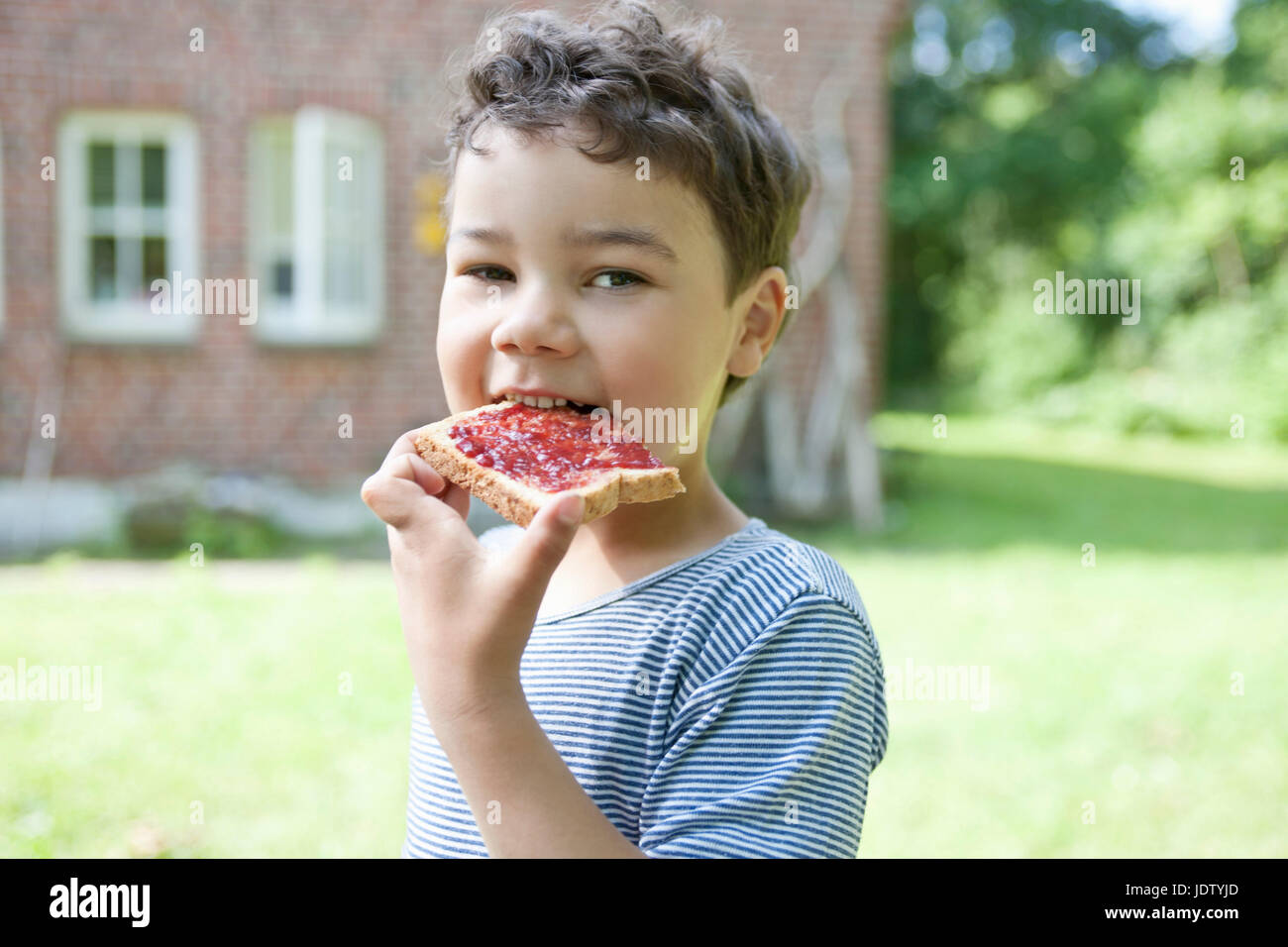 Boy eating jam on toast hi-res stock photography and images - Alamy