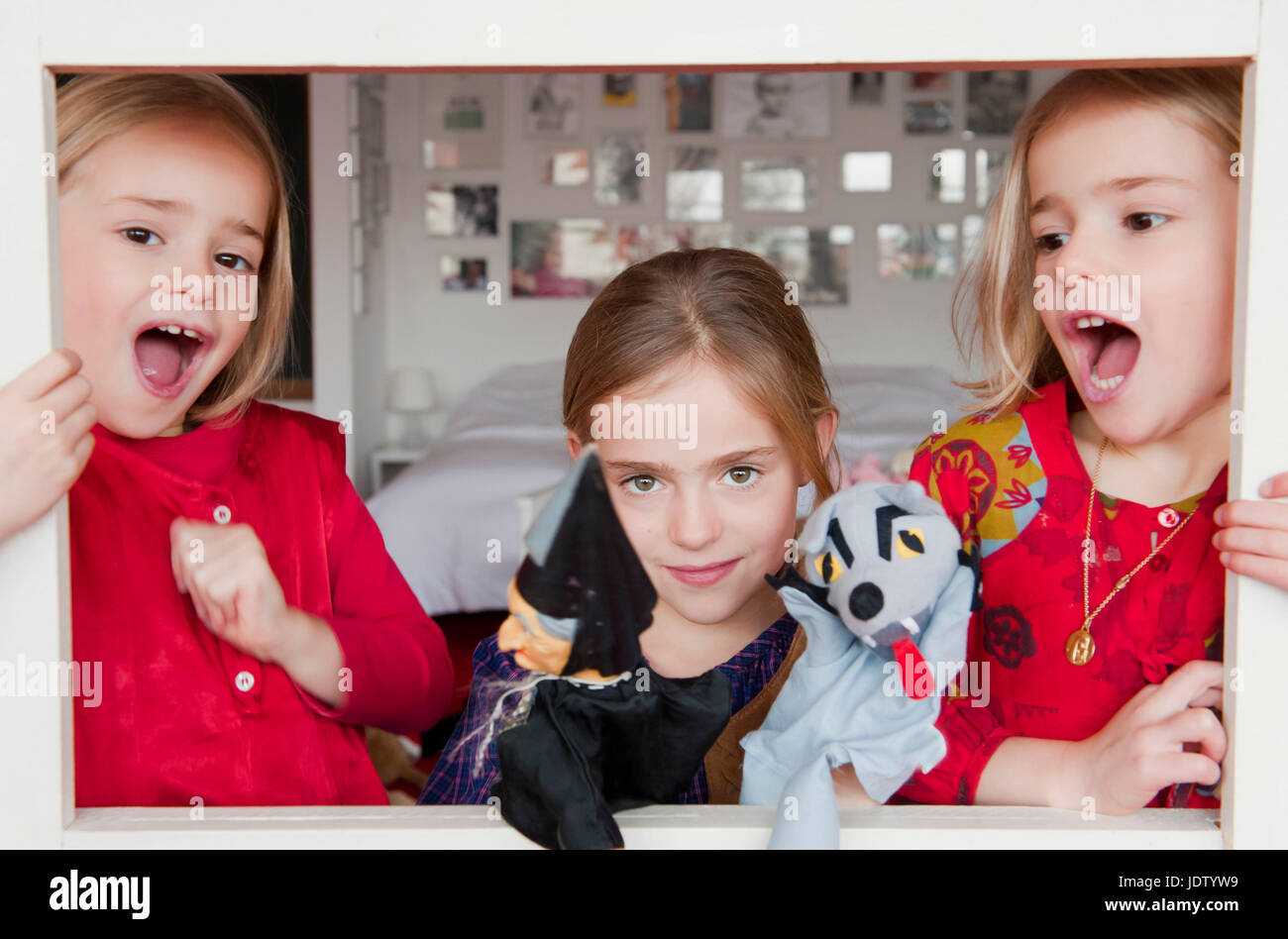 Girls having puppet show in bedroom Stock Photo - Alamy