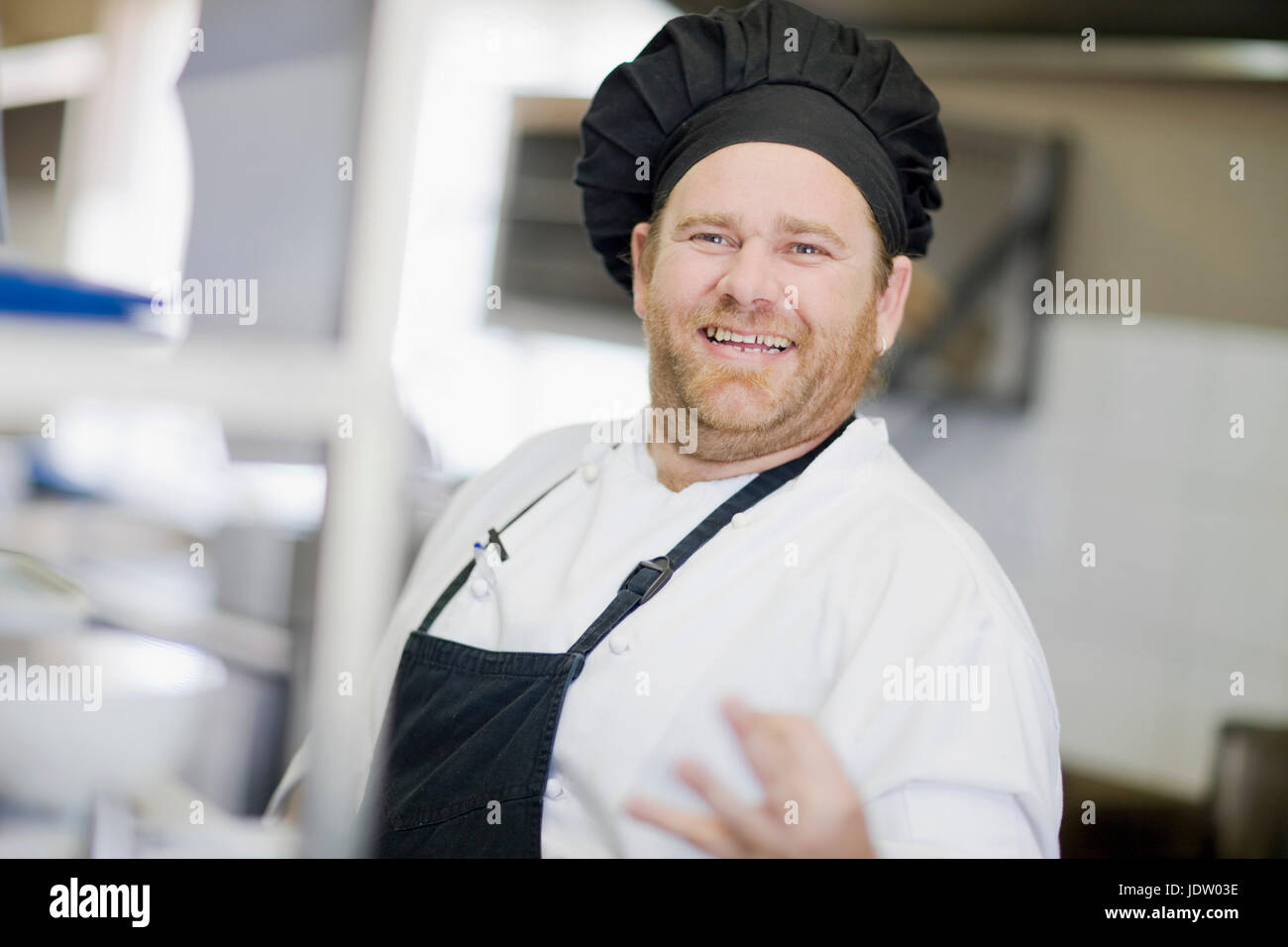 Smiling chef at work in kitchen Stock Photo - Alamy