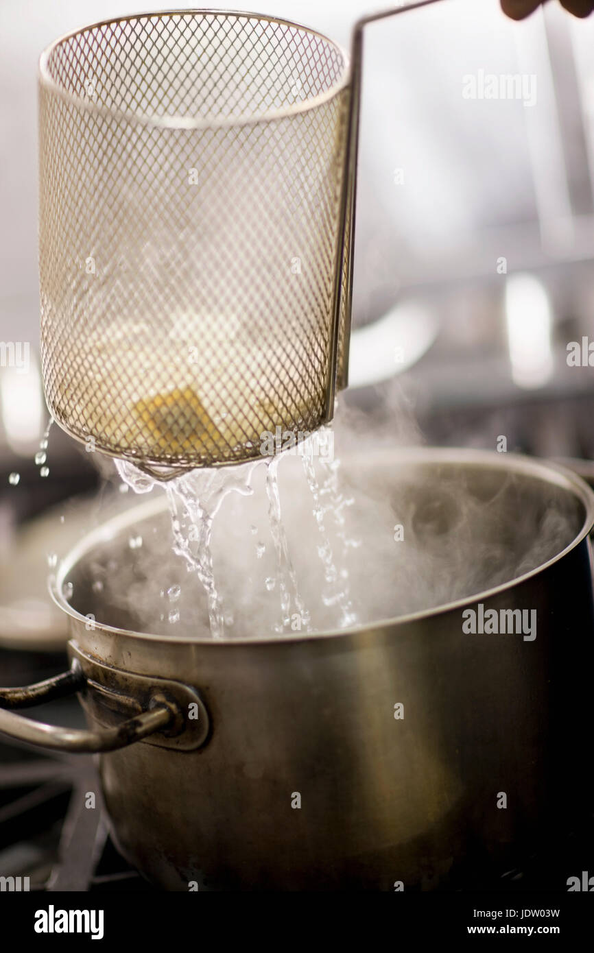 Chef cooking pasta in kitchen Stock Photo - Alamy