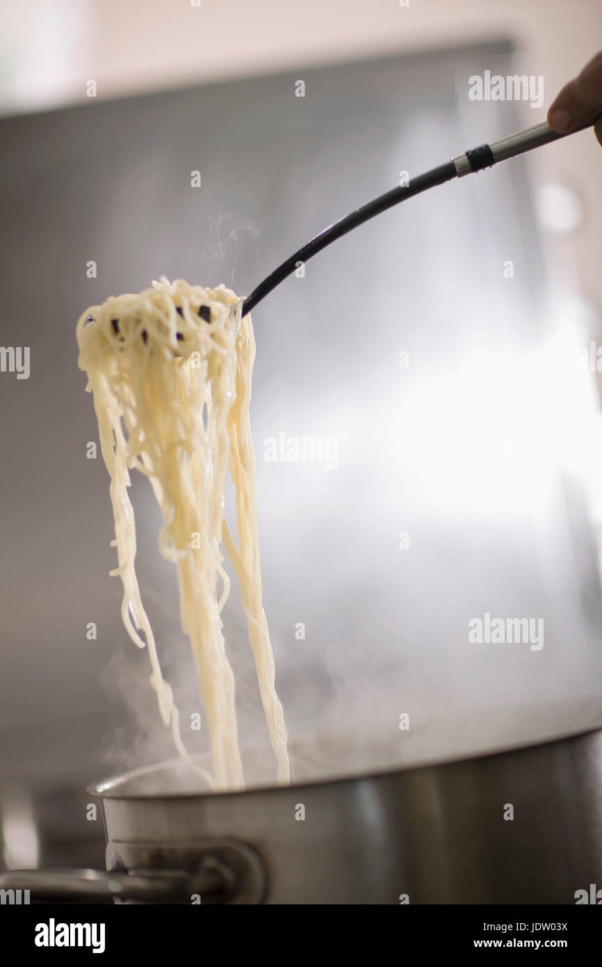 Chef cooking pasta in kitchen Stock Photo - Alamy