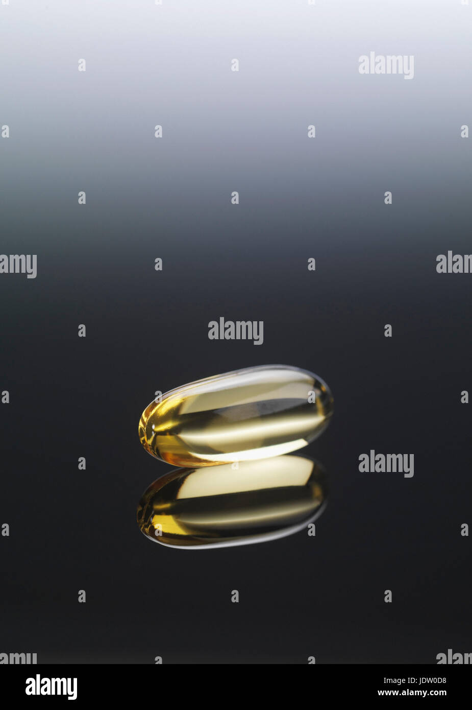 Close up of pill on reflective surface Stock Photo - Alamy