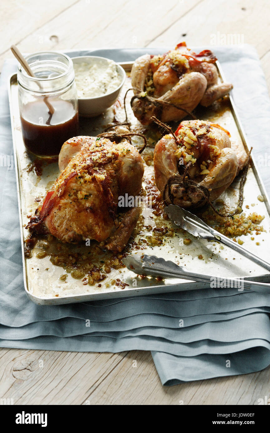 Tray of roasted stuffed chickens Stock Photo - Alamy