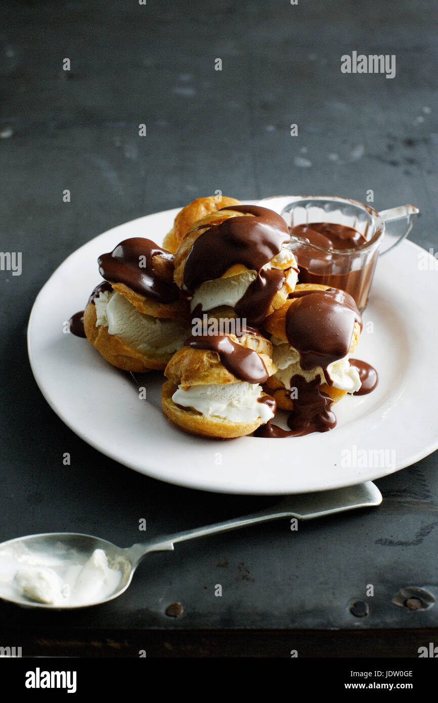 Plate of cream puffs with chocolate Stock Photo - Alamy