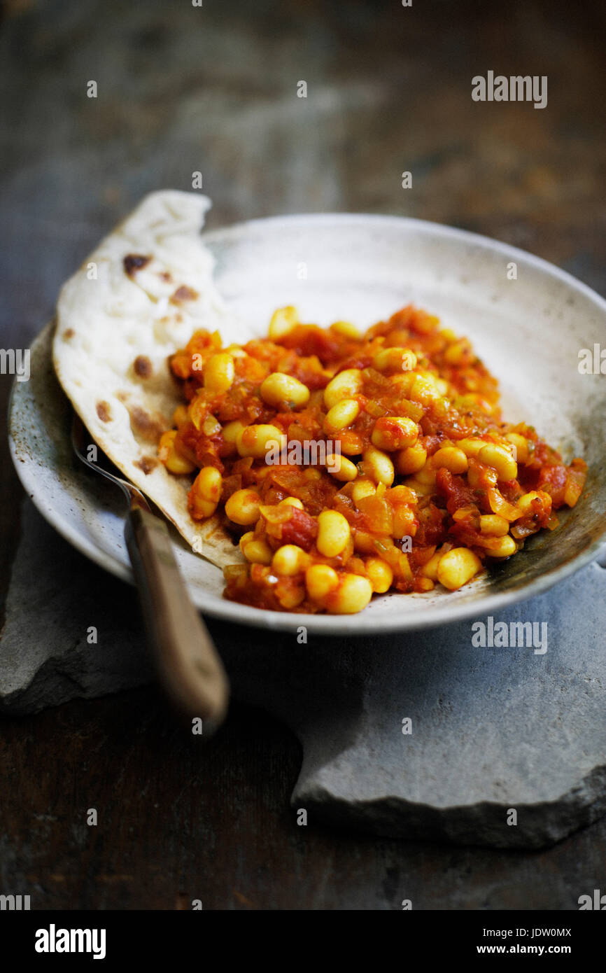 Plate of beans with flatbread Stock Photo - Alamy