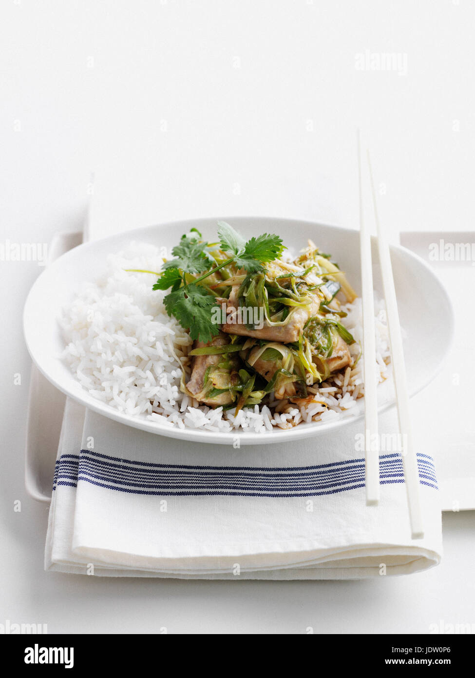 Bowl of fish with herbs and rice Stock Photo - Alamy
