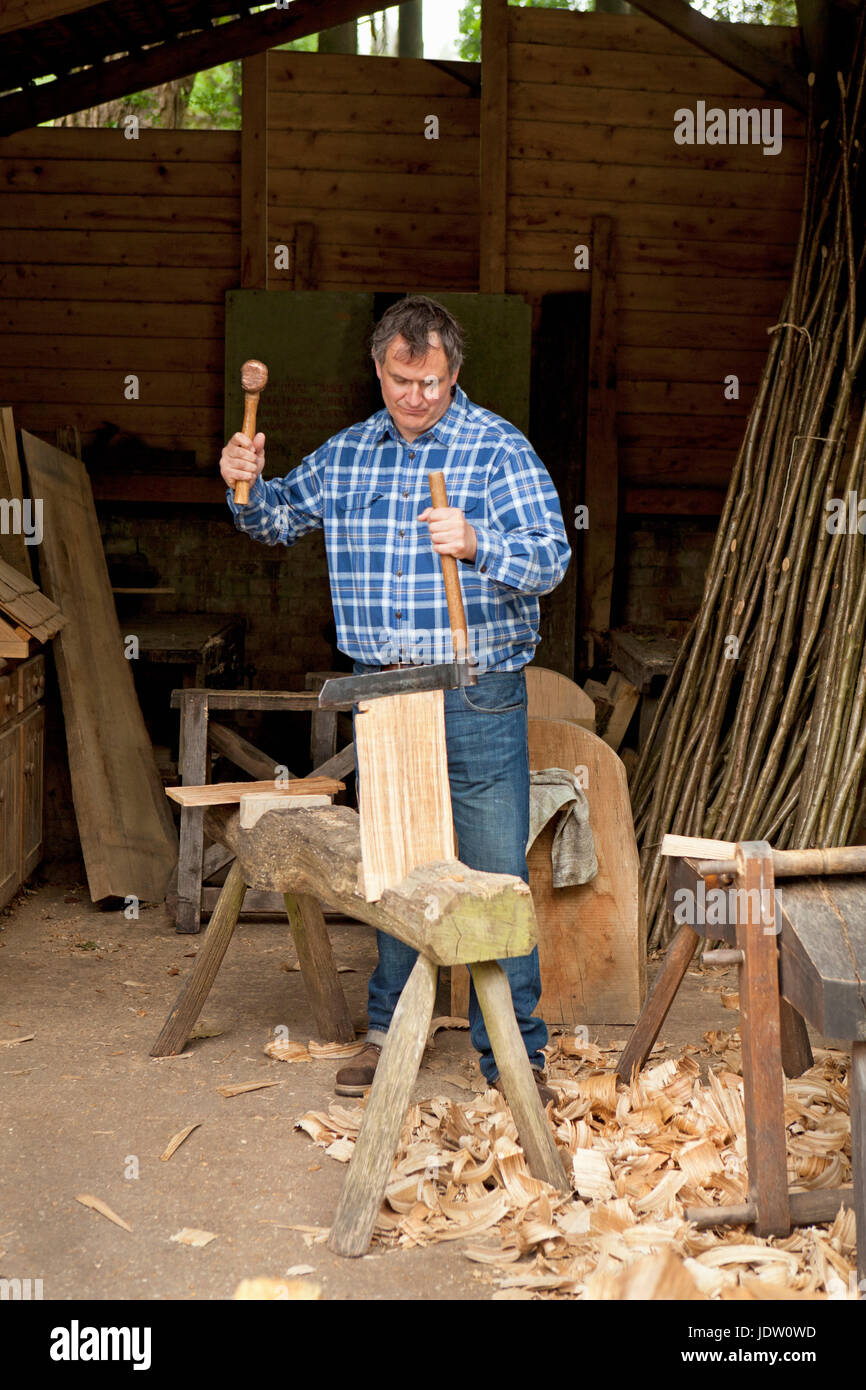 Older man carving wood in shop Stock Photo - Alamy