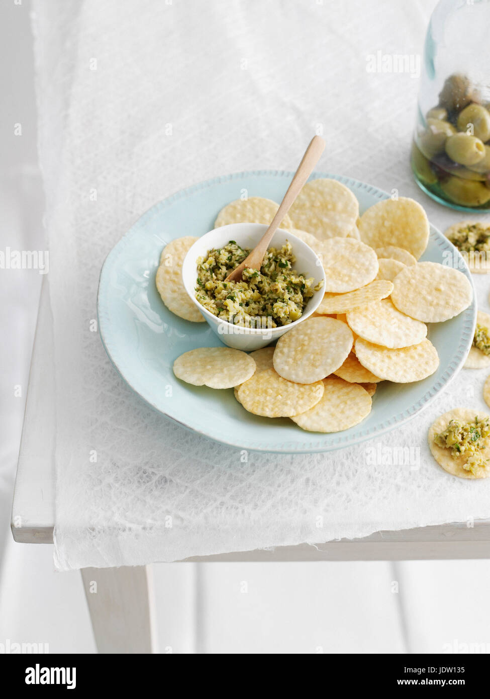Plate of crackers with topping Stock Photo - Alamy