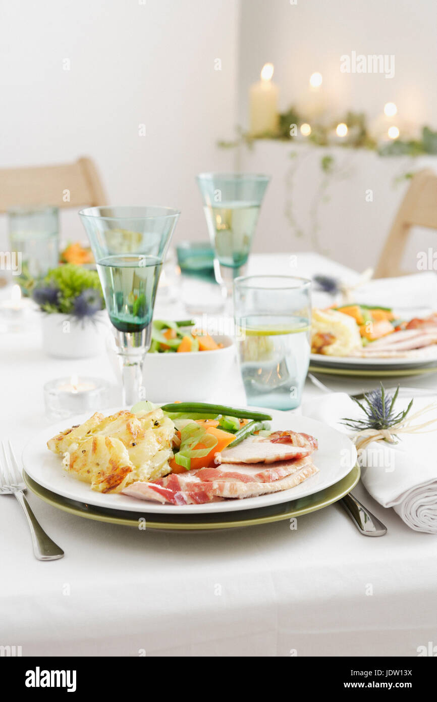 Plates of food on dinner table Stock Photo - Alamy