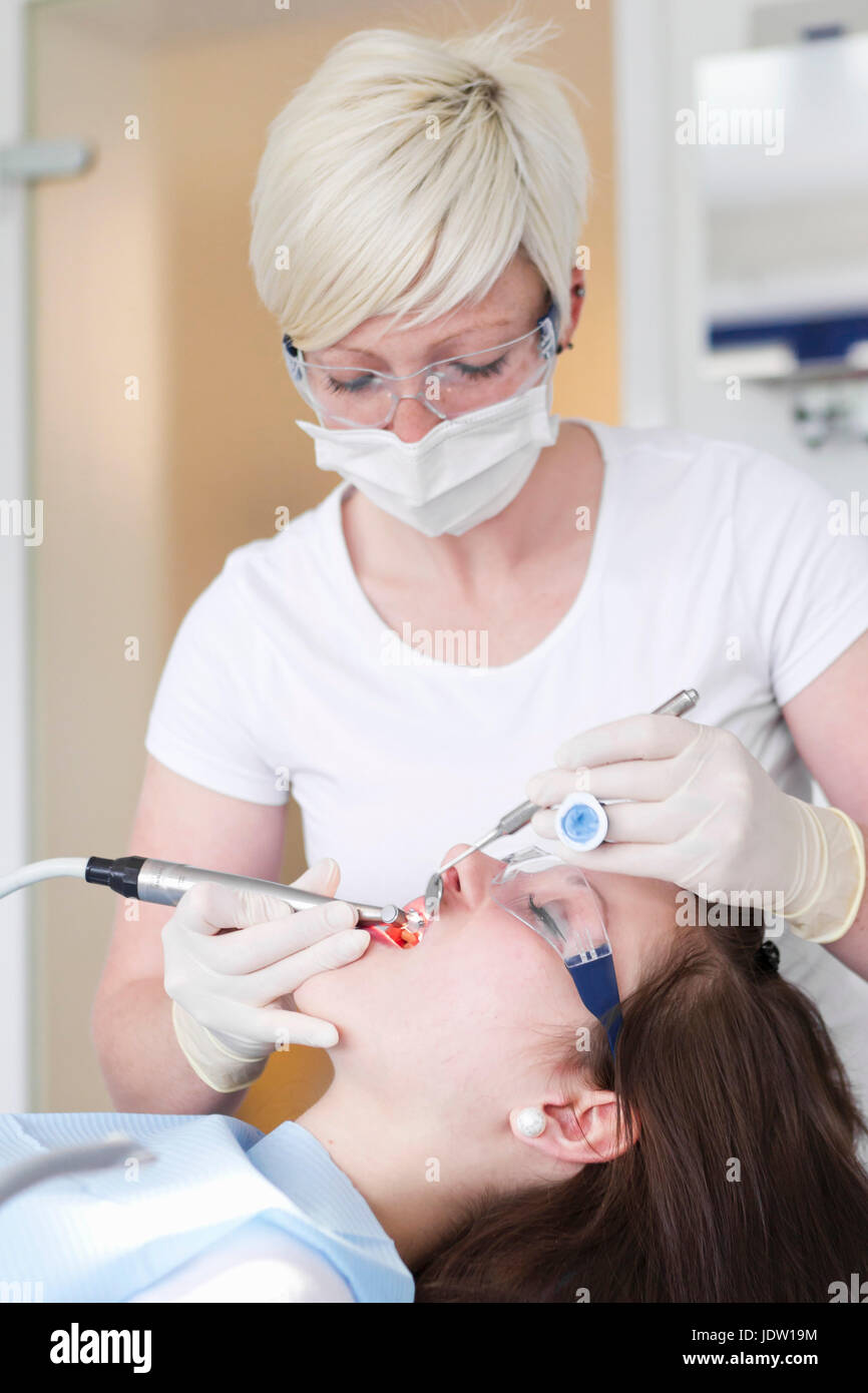 Dentist working on patients teeth Stock Photo - Alamy