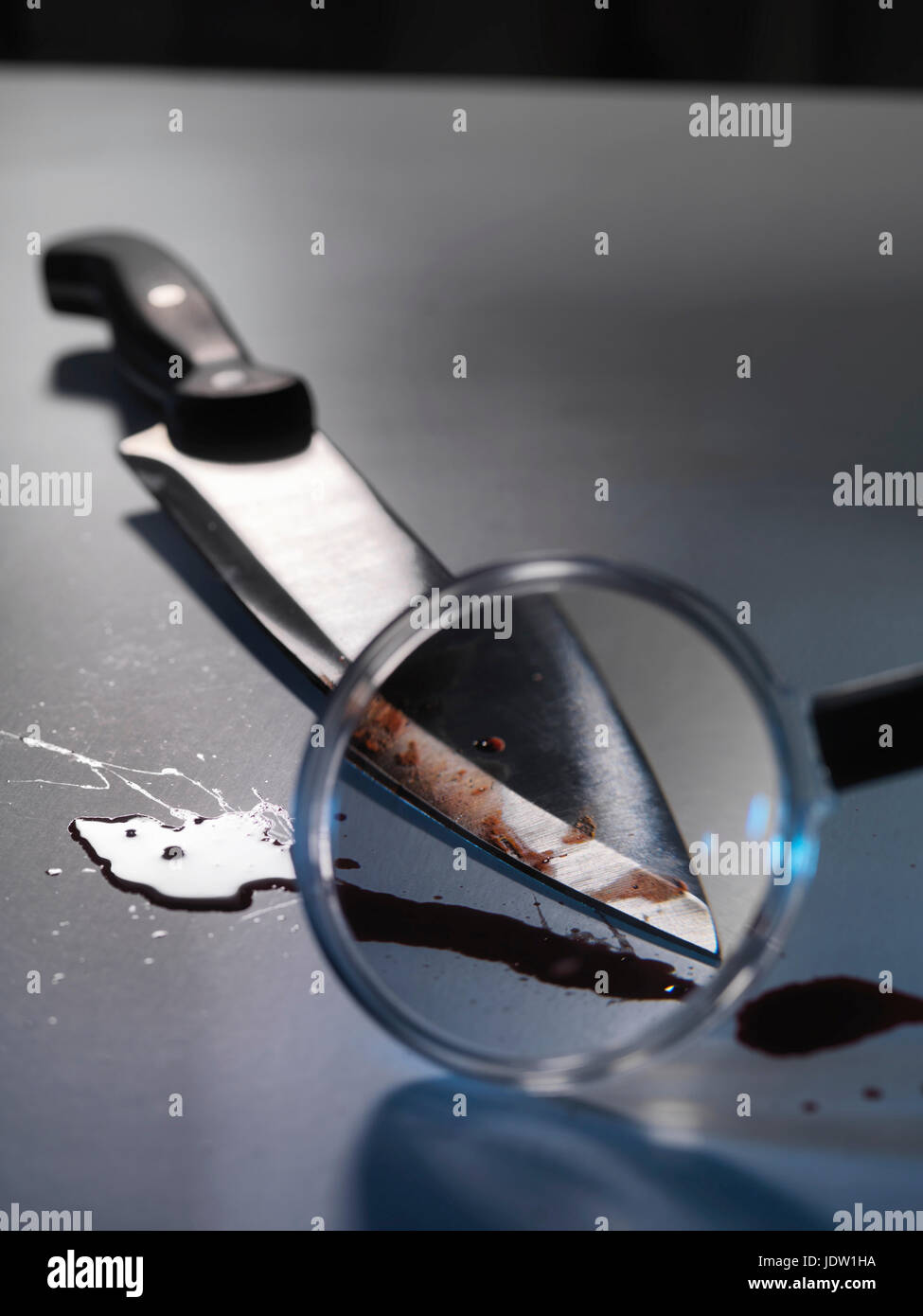 Magnifying glass on bloody knife Stock Photo - Alamy